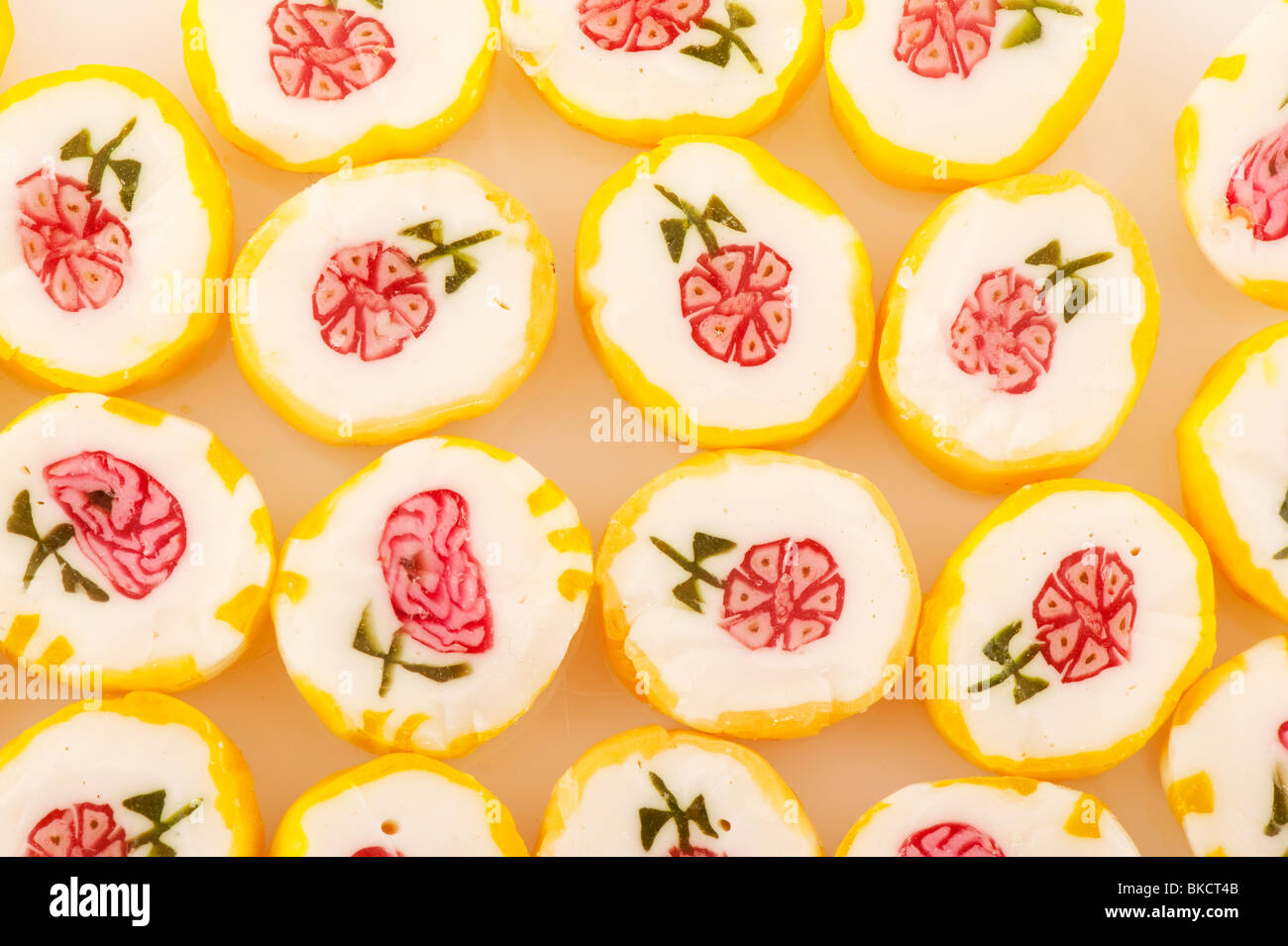 Many old fashioned sweets in yellow with flowers Stock Photo - Alamy