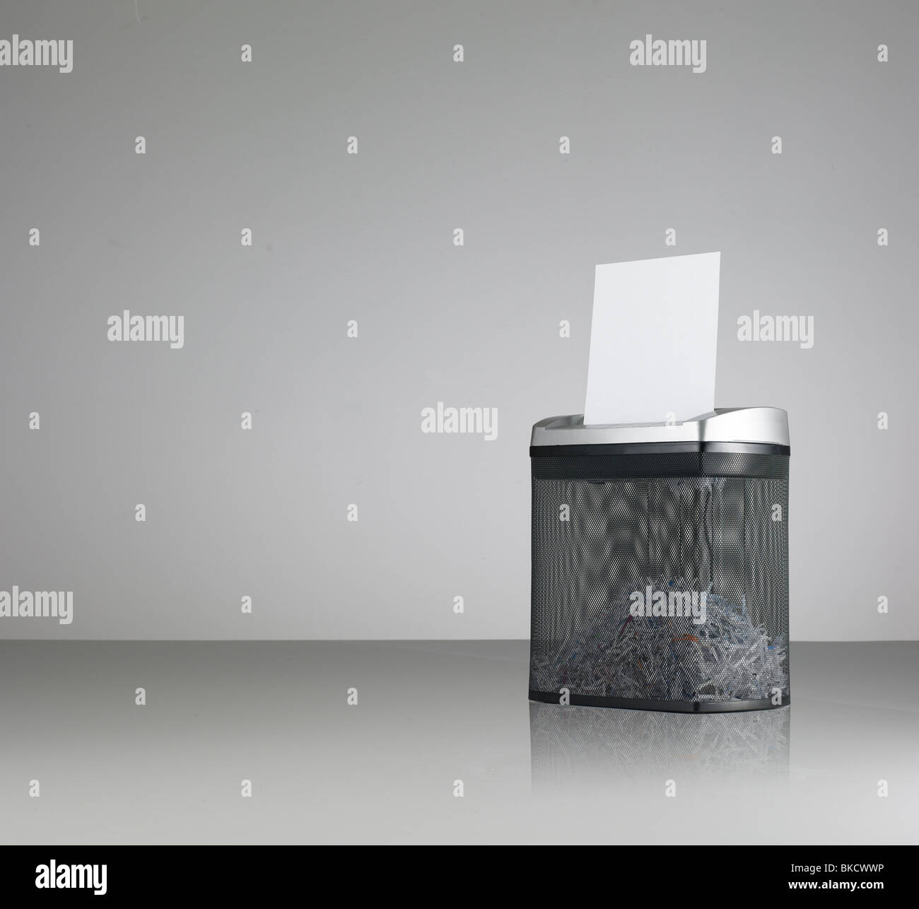 Paper shredder on a grey background Stock Photo - Alamy