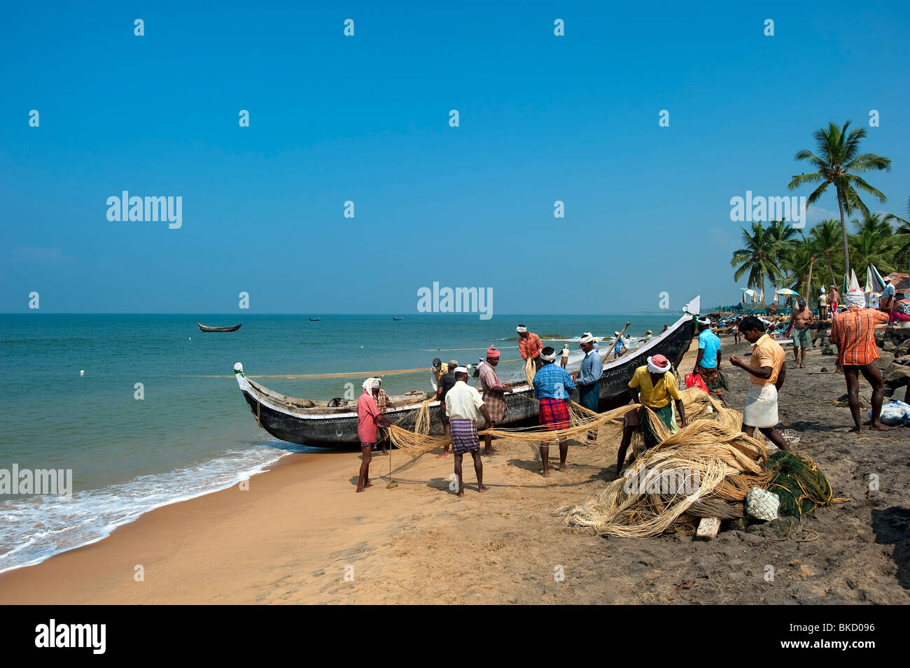 Samudra Beach with Fishermen, Kovalam, Kerala, India Stock Photo - Alamy