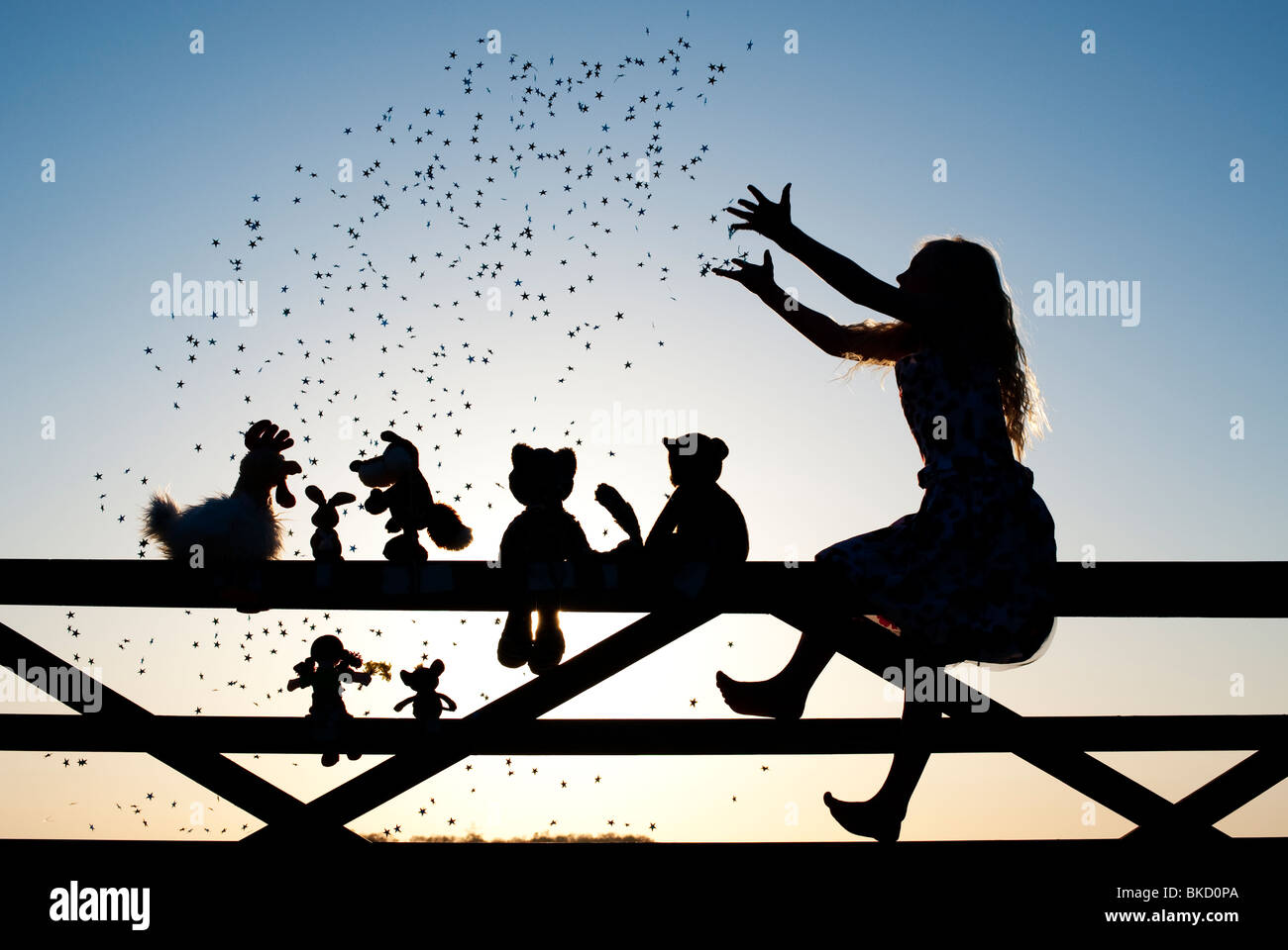 Girl throwing stars over a Rag doll, chicken, fox, rabbit and teddy ...