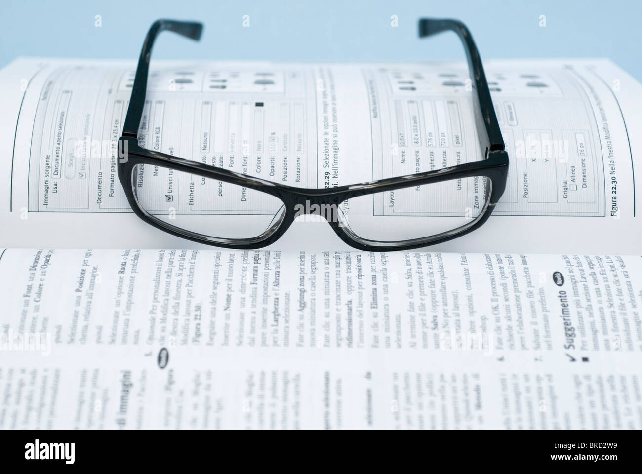 Glasses lying on an open manual book Stock Photo - Alamy