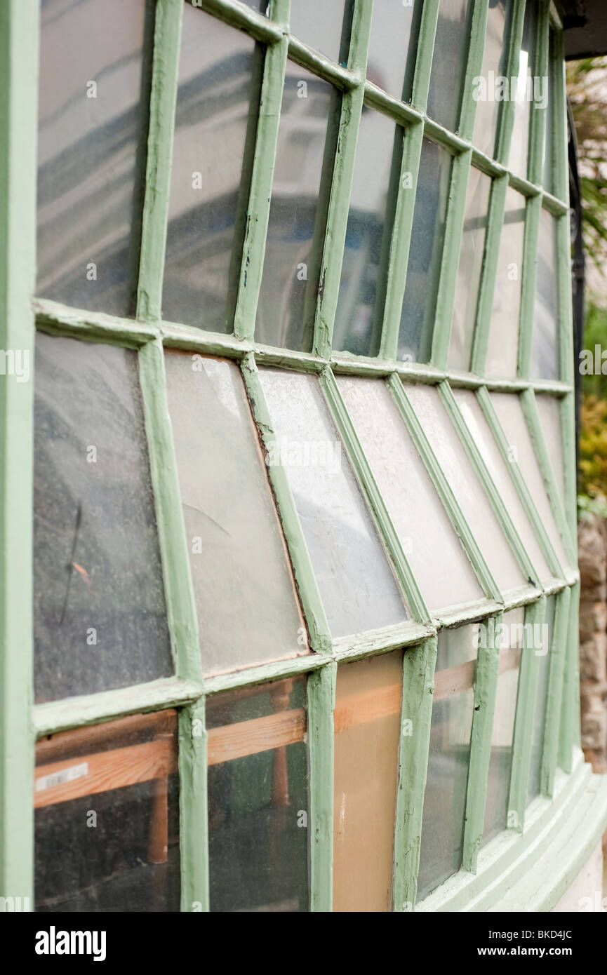 Twisted bent old shop window with small panes Stock Photo - Alamy