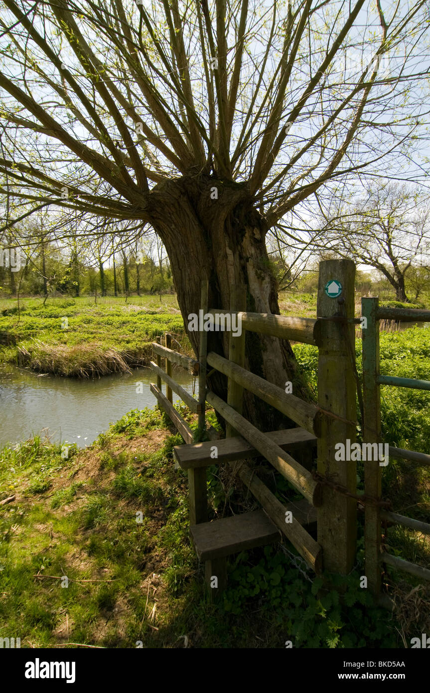 A stile with an arrow sign showing the route of a DEFRA conservation ...