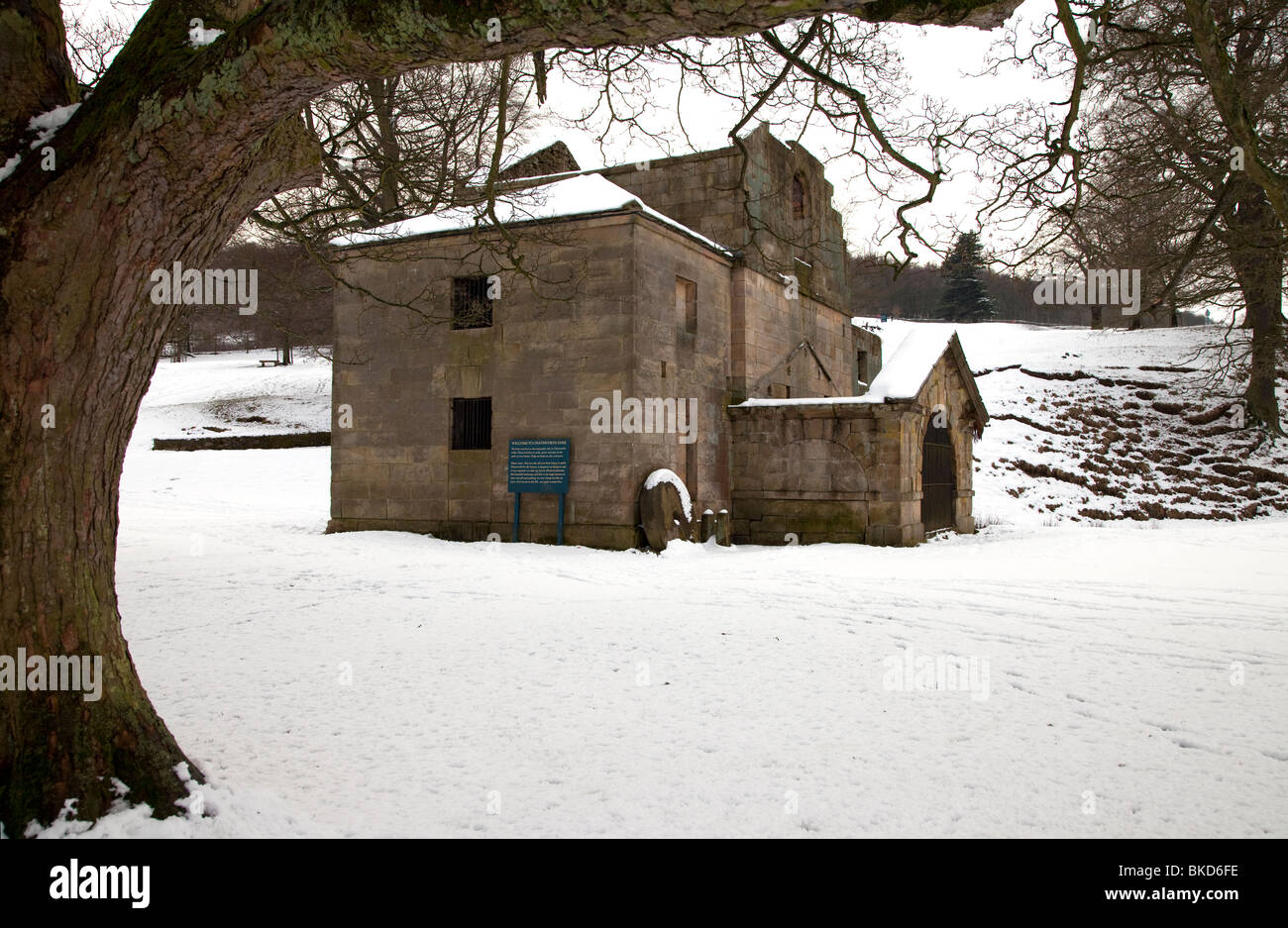The old Mill covered in snow at Chatsworth in Derbyshire Peak District ...