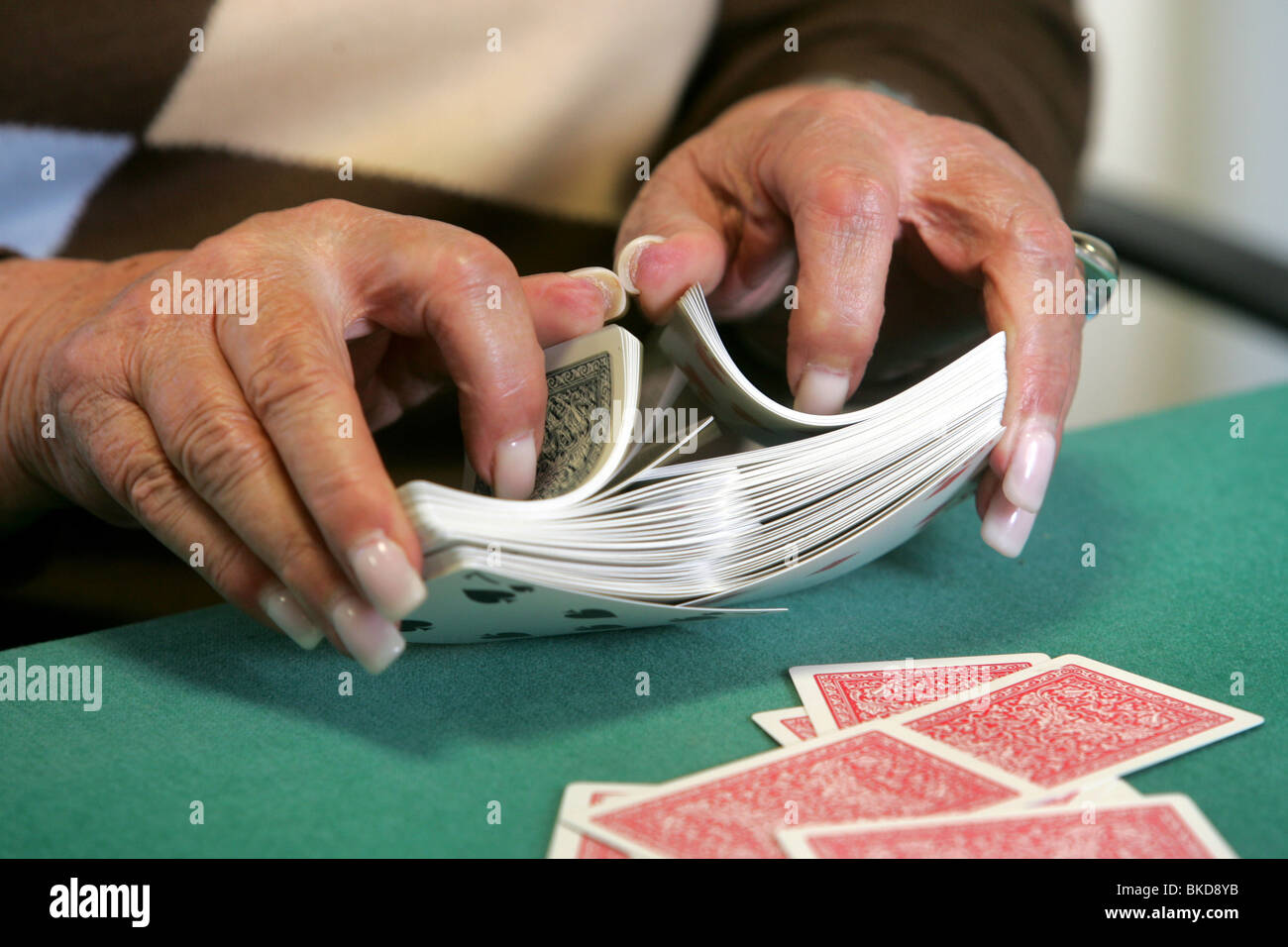 Woman shuffling cards Stock Photo - Alamy