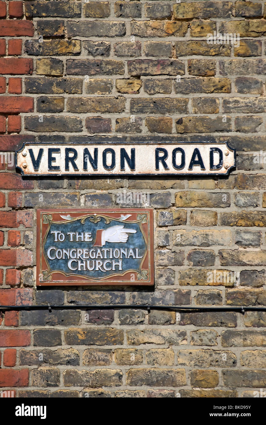 to the congregational church sign with pointing hand in ceramic tile on ...