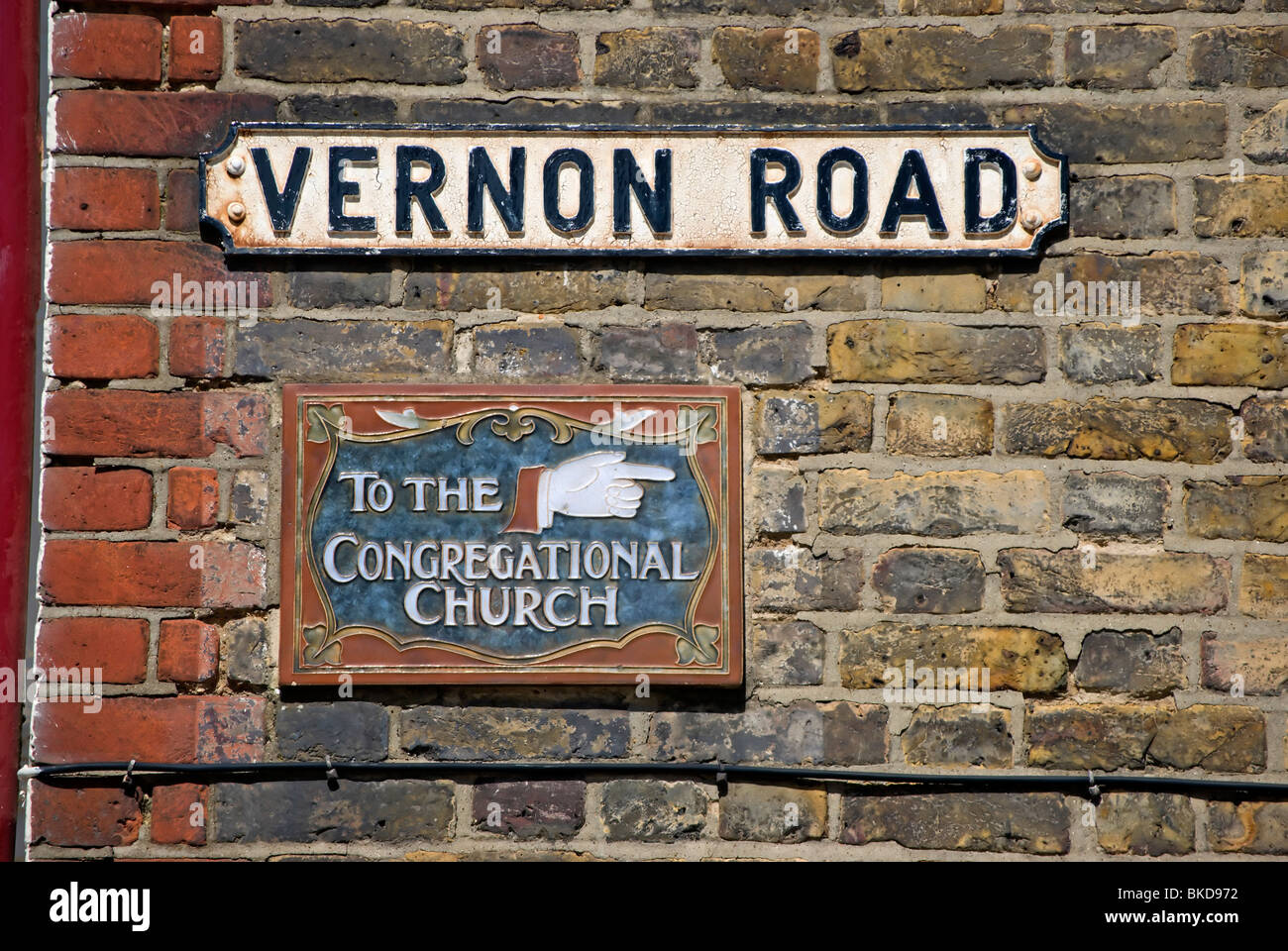 to the congregational church sign with pointing hand in ceramic tile on ...
