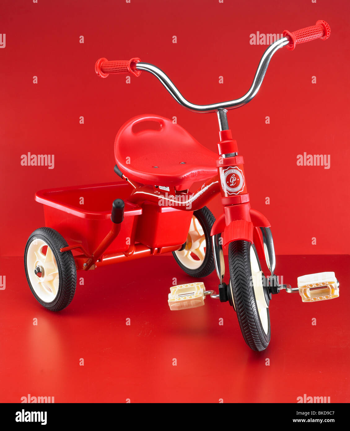red tricycle red background Stock Photo - Alamy