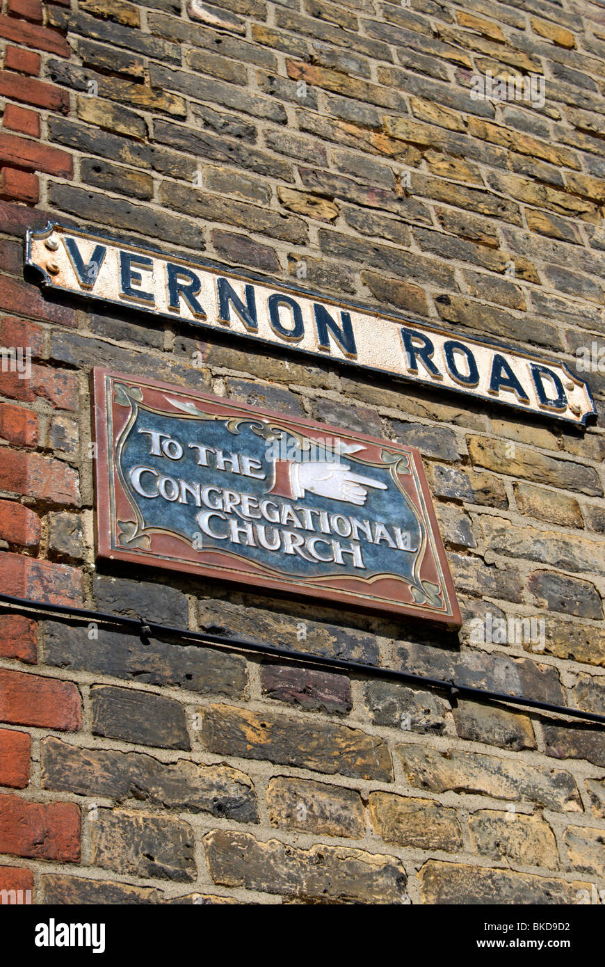 to the congregational church sign with pointing hand in ceramic tile on ...