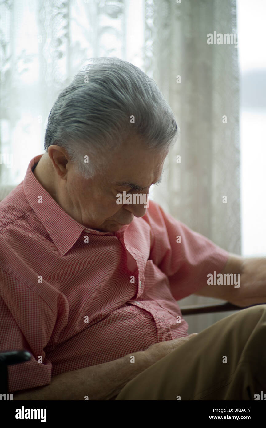 Old man sleeping in living room chair Stock Photo - Alamy