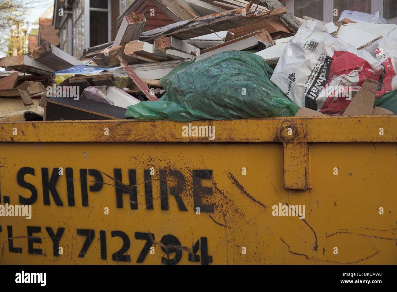 Builders skip filled with building rubble Stock Photo - Alamy