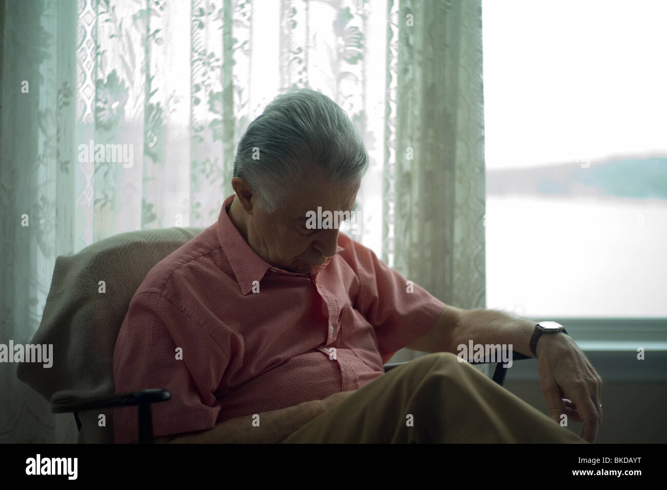 Old man sleeping in living room chair Stock Photo - Alamy