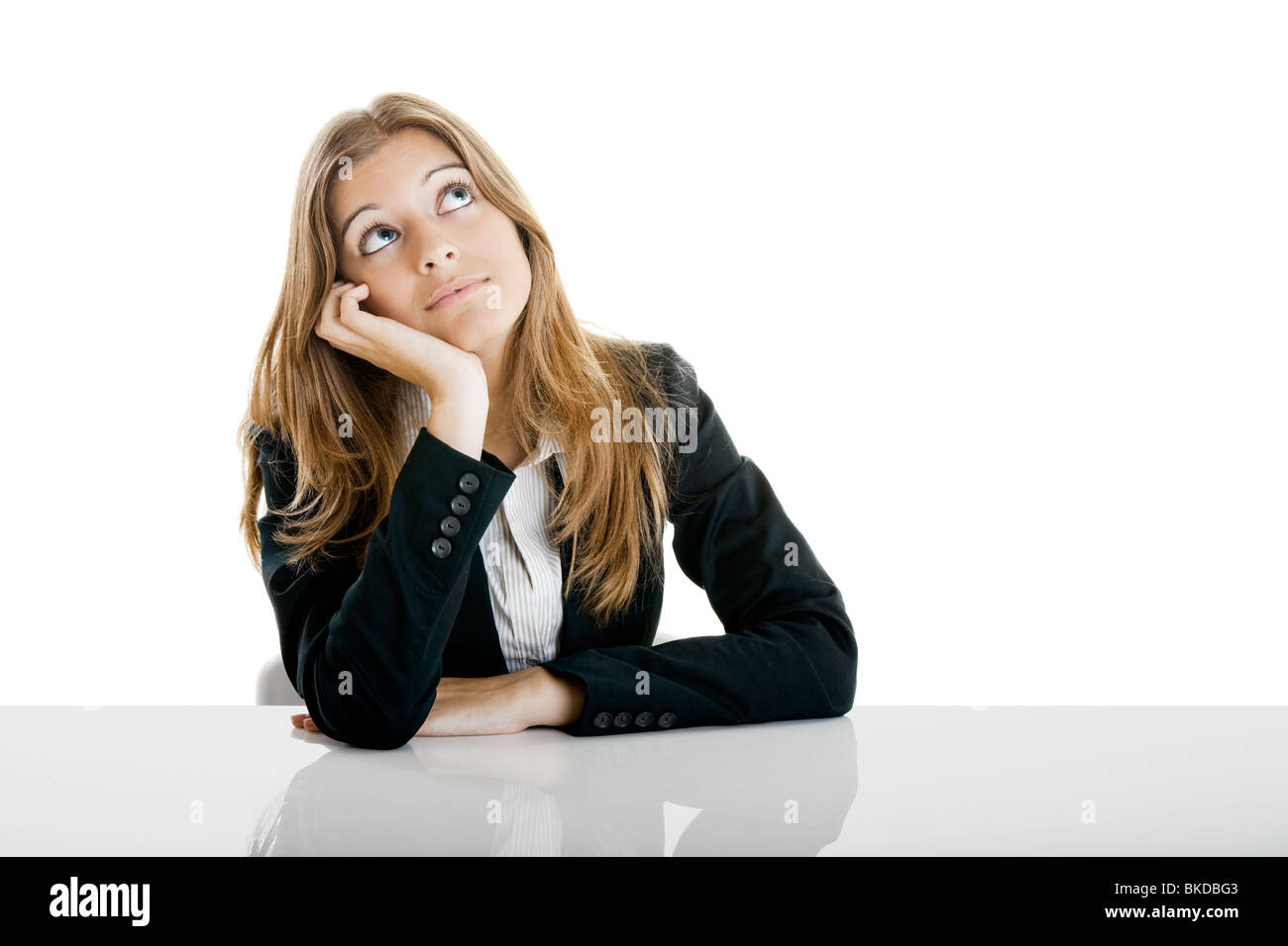 Portrait of a young and beautiful business woman thinking in something ...