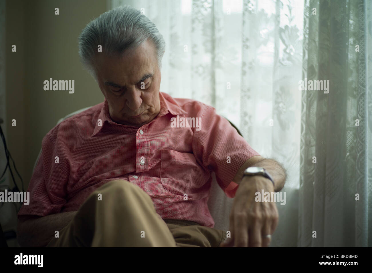 Old man sleeping in living room chair Stock Photo - Alamy