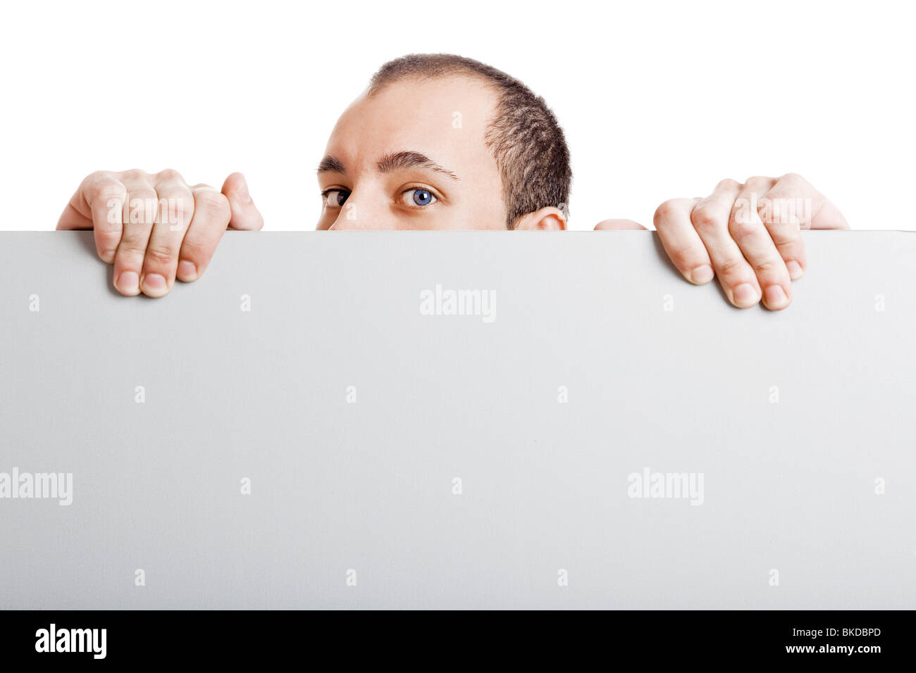 Businessman holding a blank billboard and peeking over it, isolated on ...
