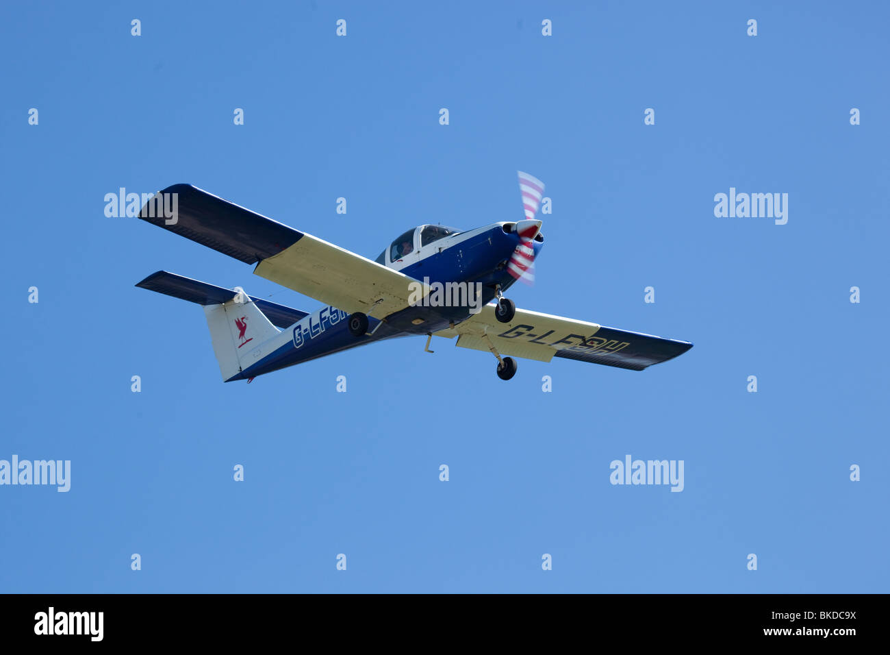 A Light propeller driven aircraft flying against a blue sky Stock Photo ...