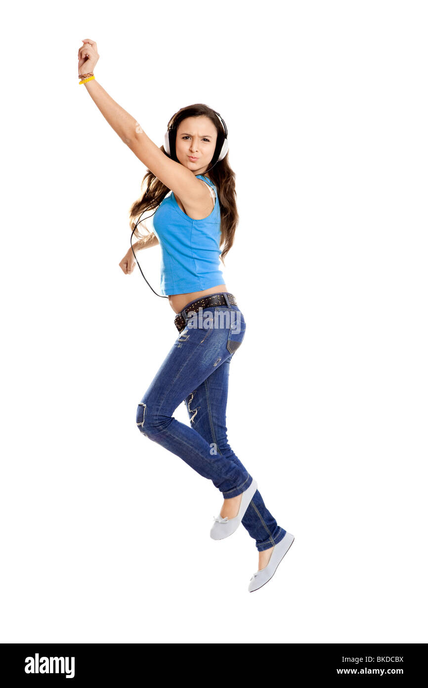 Beautiful young girl dancing and listen music, isolated on white Stock ...