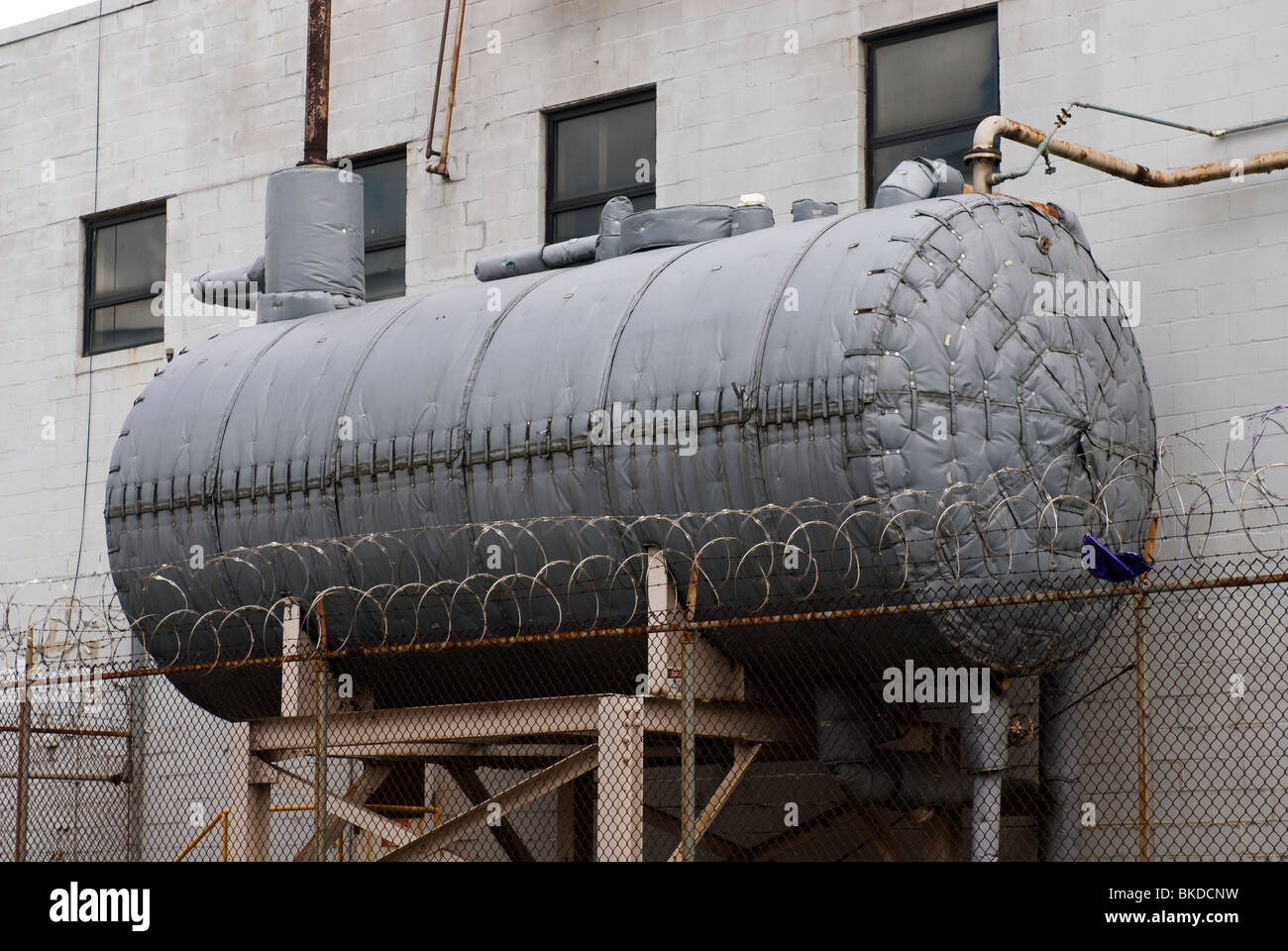 A boiler mounted outside a building is wrapped to conserve energy and ...