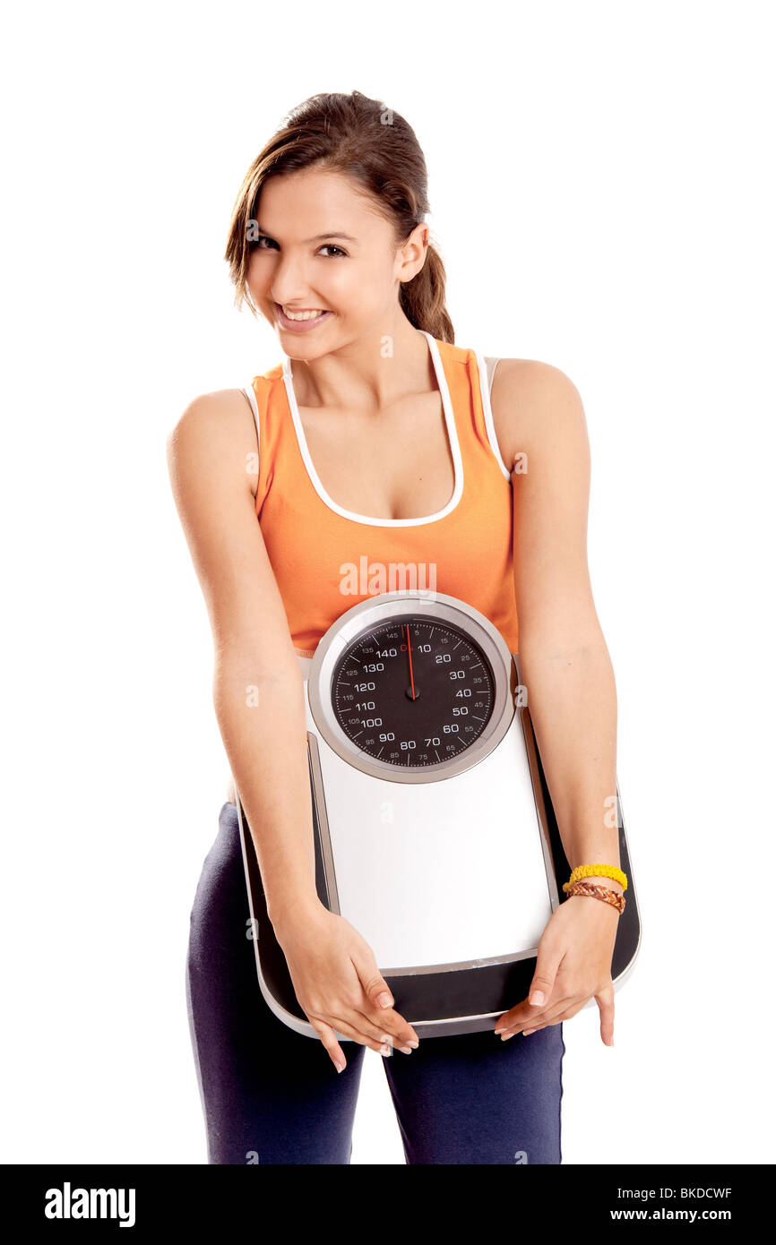 Portrait of a beautiful athletic girl holding a scale, isolated on ...