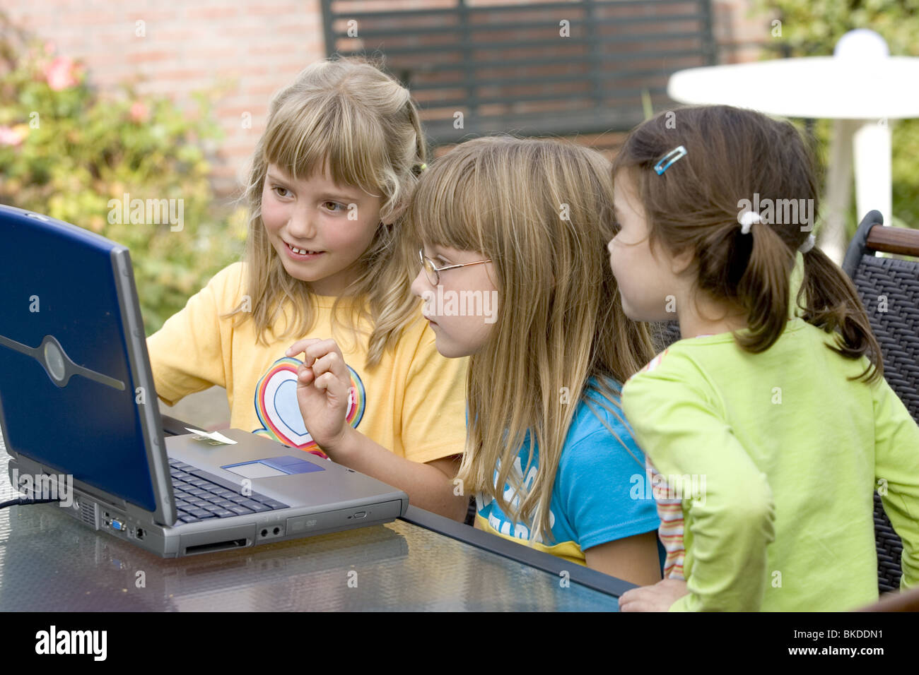 Young children in 2000s use a laptop computer , looking at screen ...