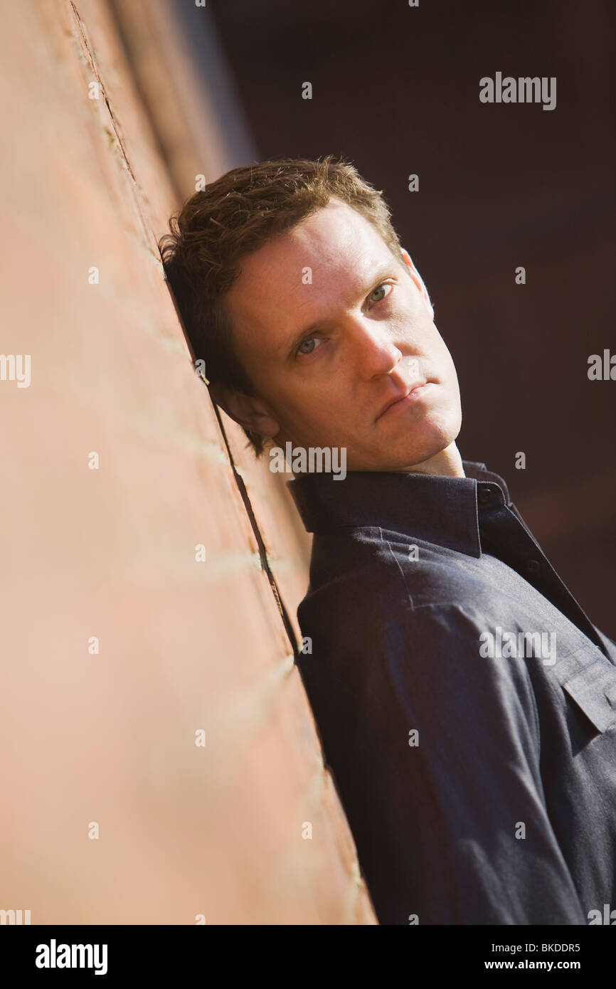 Man Leaning Against A Wall Stock Photo - Alamy