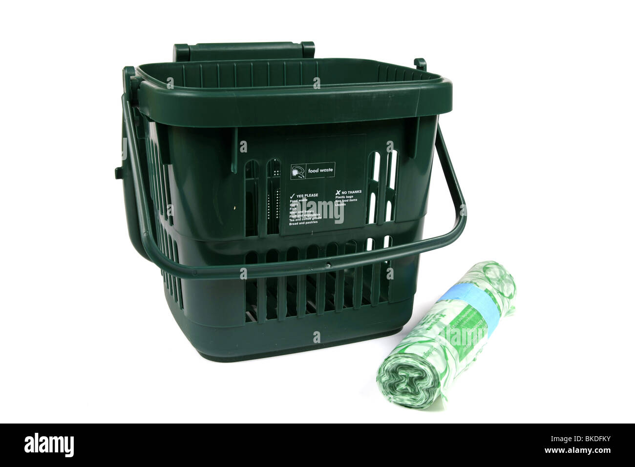 A Green food waste recycling dustbin for use in the kitchen against a ...