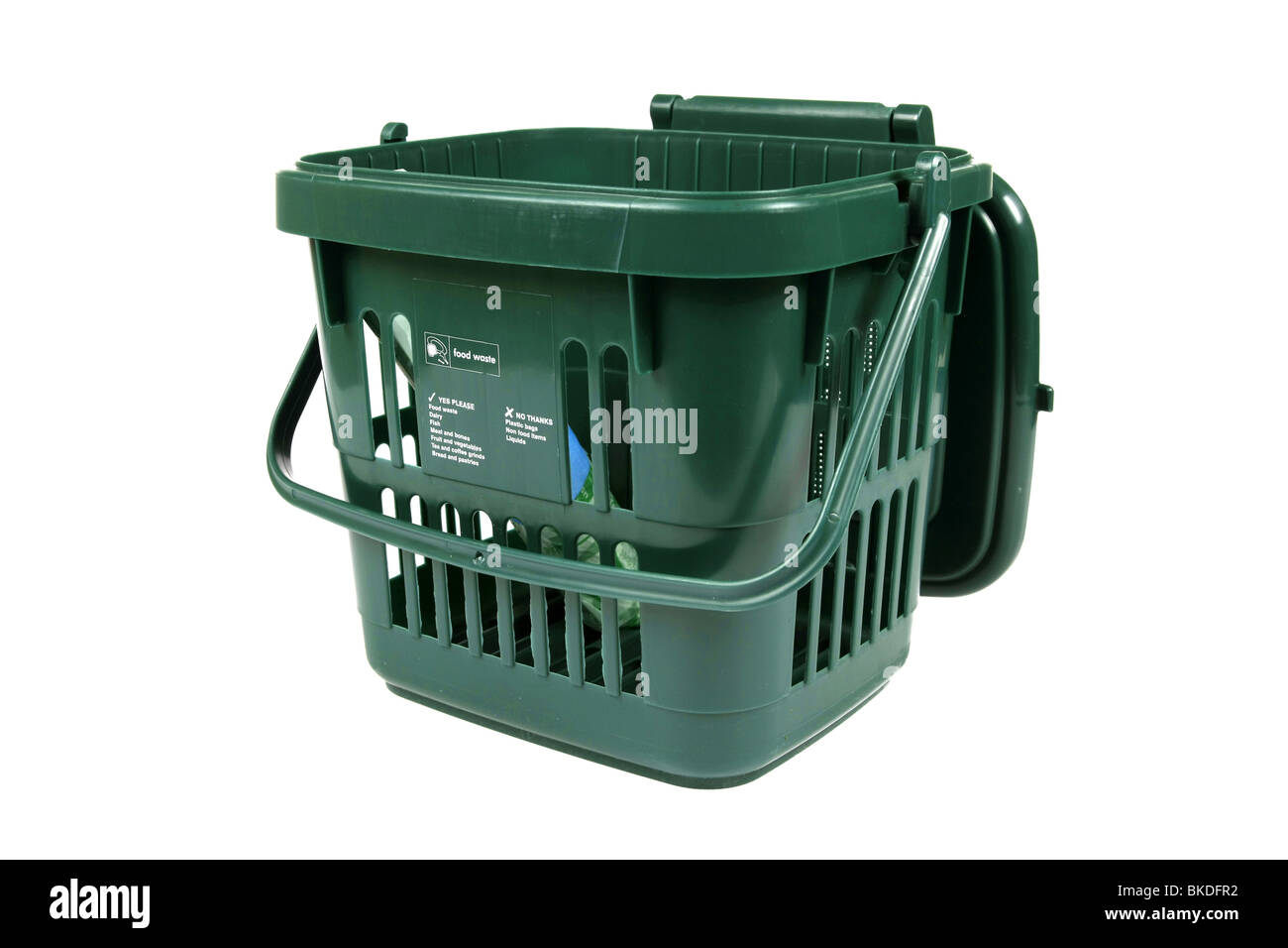 A Green food waste recycling dustbin for use in the kitchen against a ...