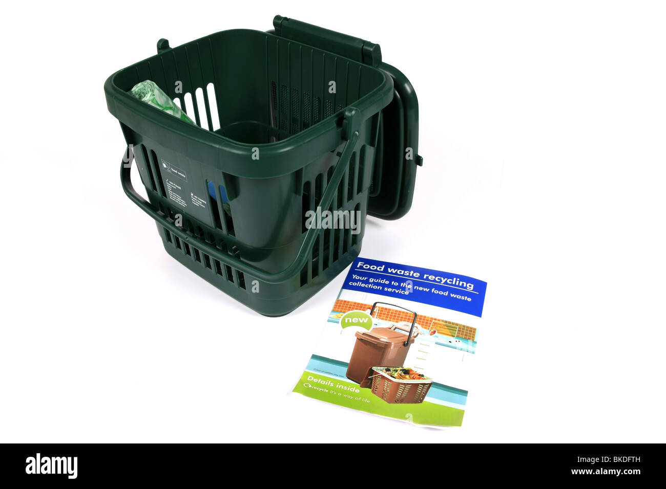 A Green food waste recycling dustbin for use in the kitchen against a ...