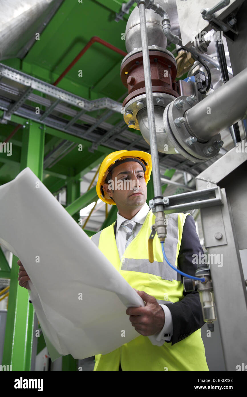 Asian factory manager wearing safety equipment checks machine Stock ...