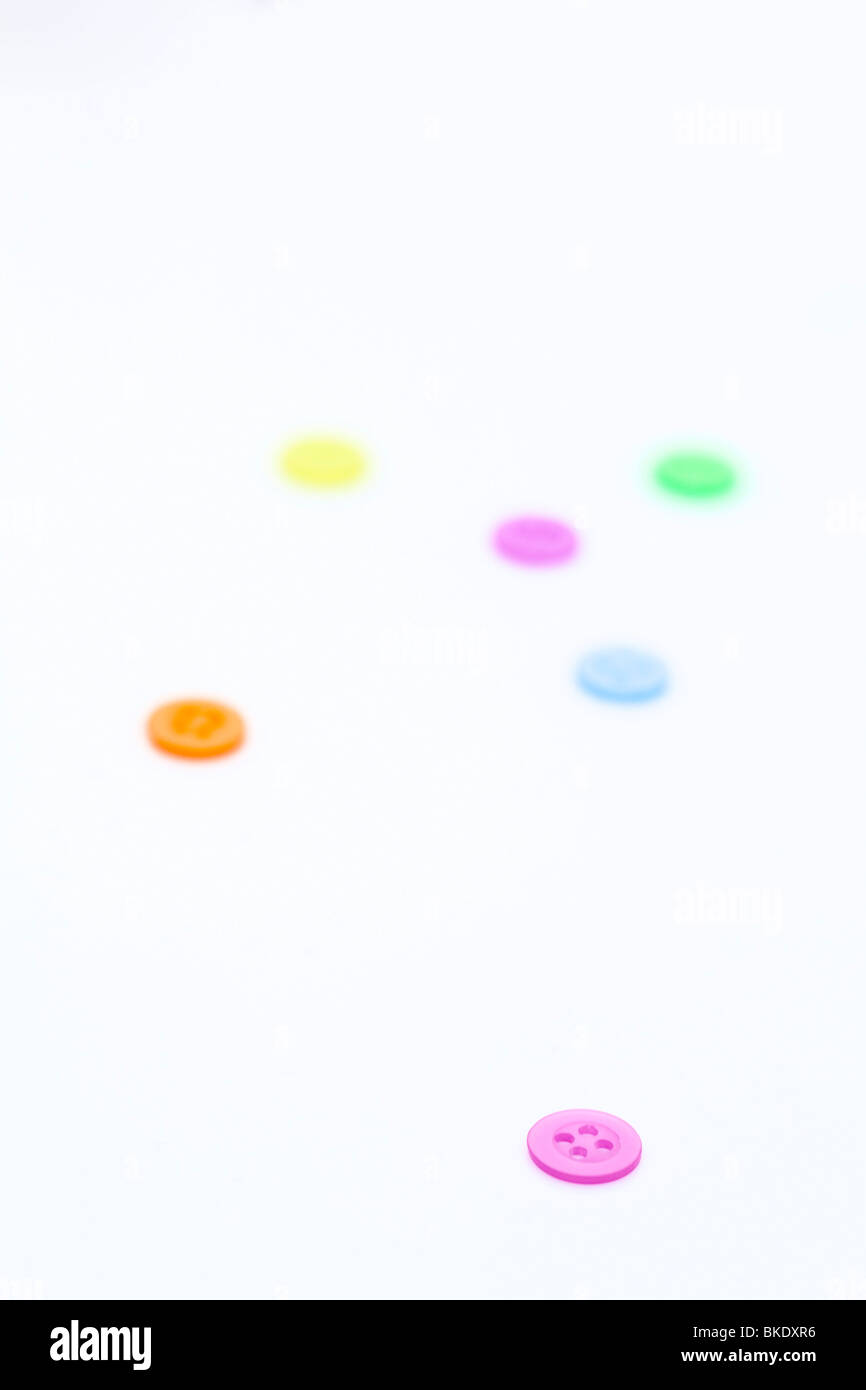 Colourful buttons spread out on a white background Stock Photo - Alamy
