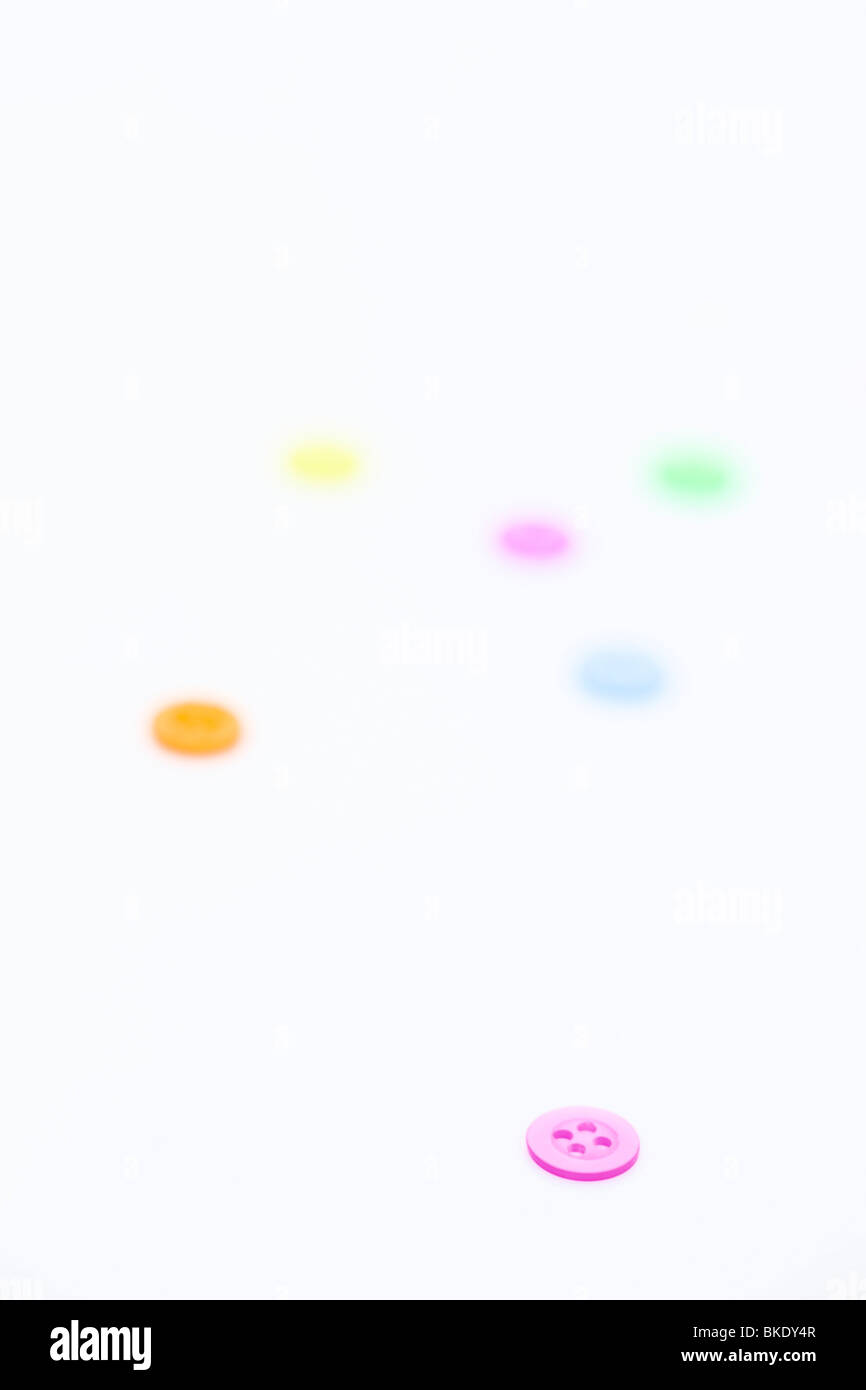 Colourful buttons spread out on a white background Stock Photo - Alamy