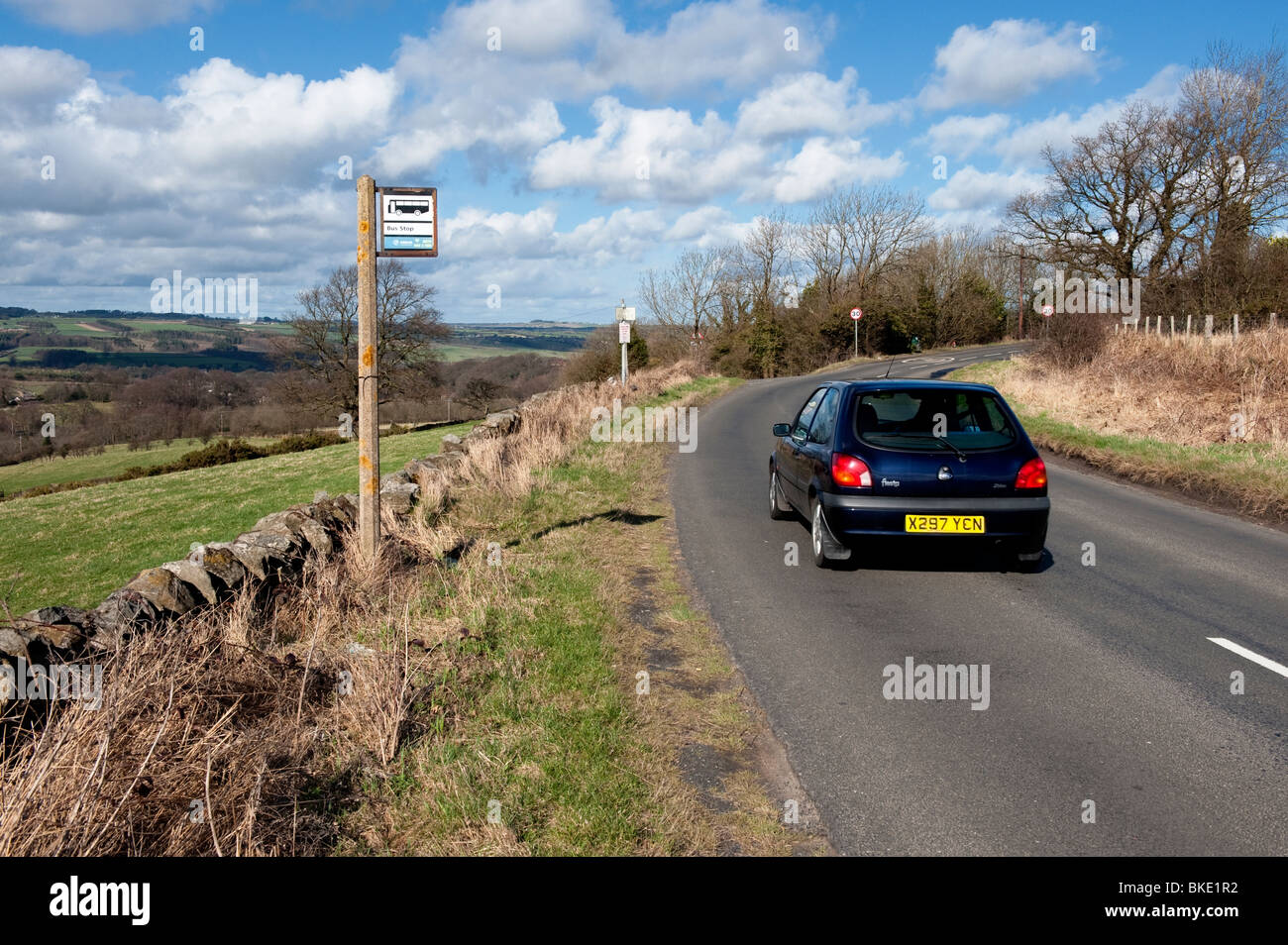 Rural road and bus stop Stock Photo - Alamy