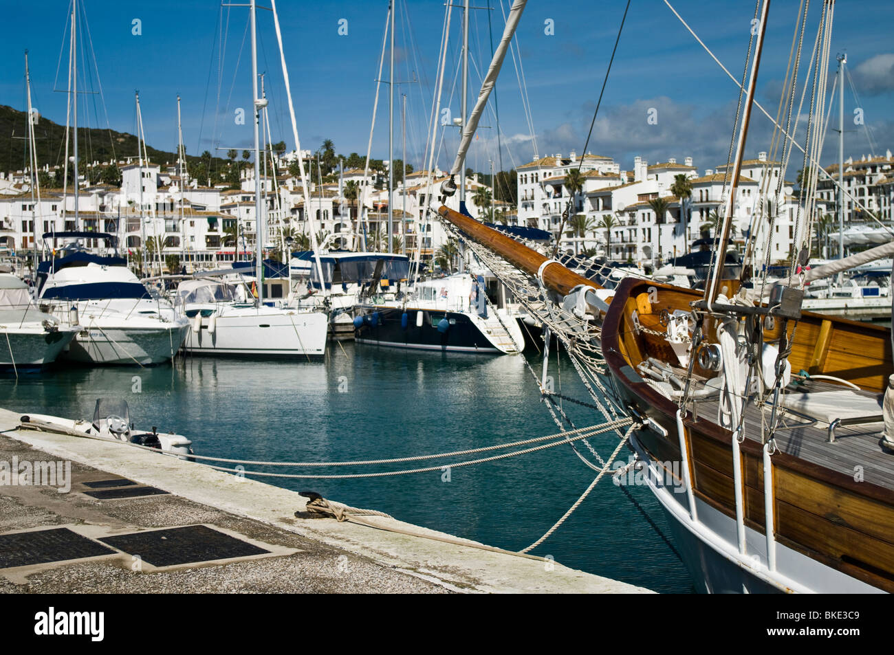 Bow and foredeck of a wooden sailing boat detailed against the backdrop ...