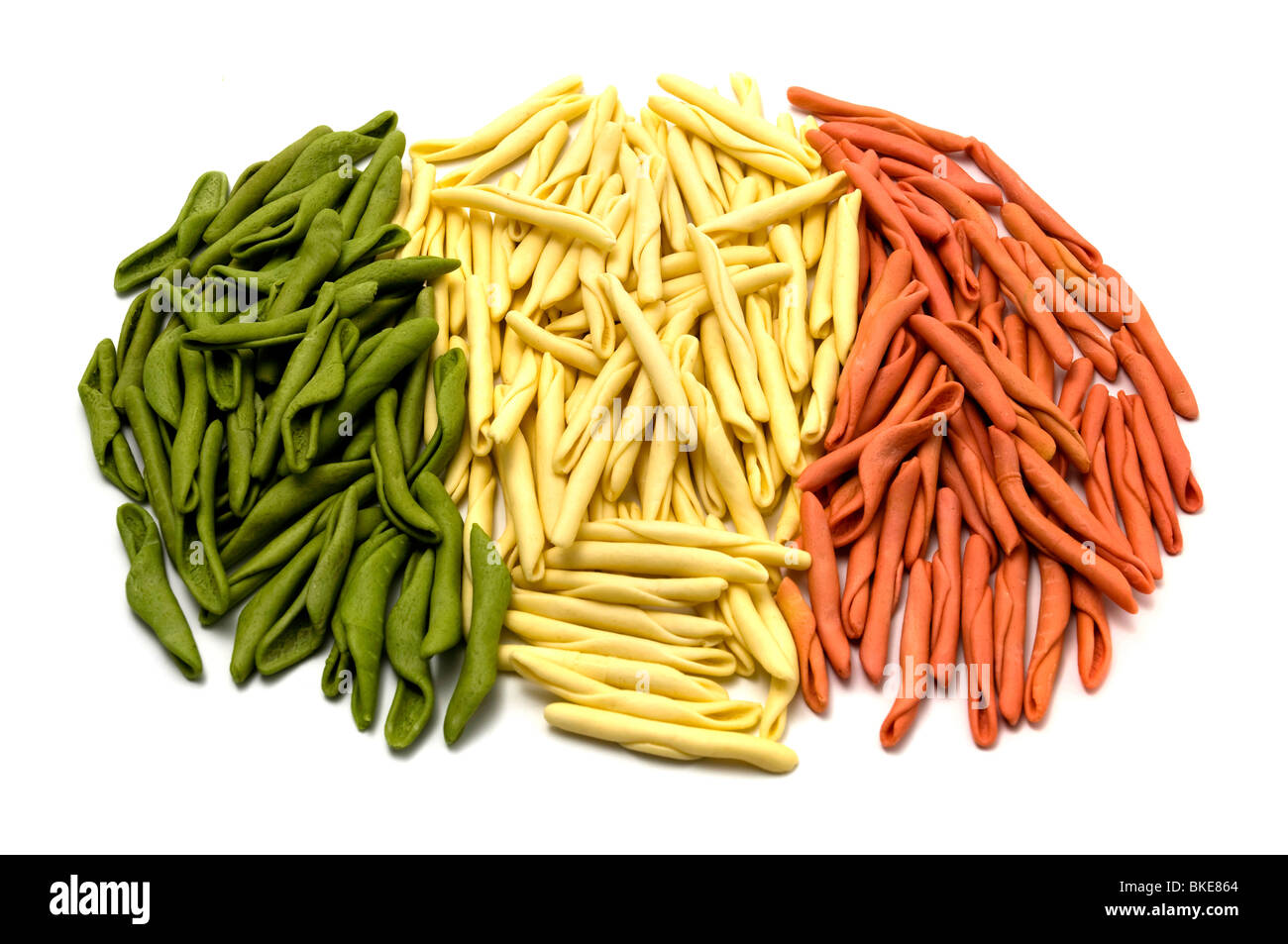 Mixed pasta with the colors of the Italian flag on a white background ...