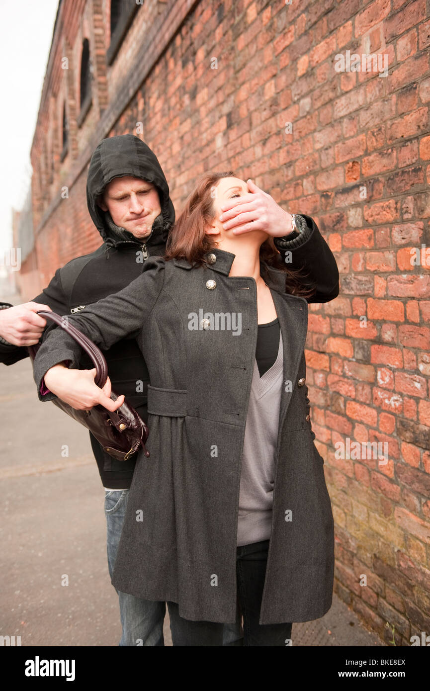 Lone woman walking along street with handbag thug / criminal attacking ...
