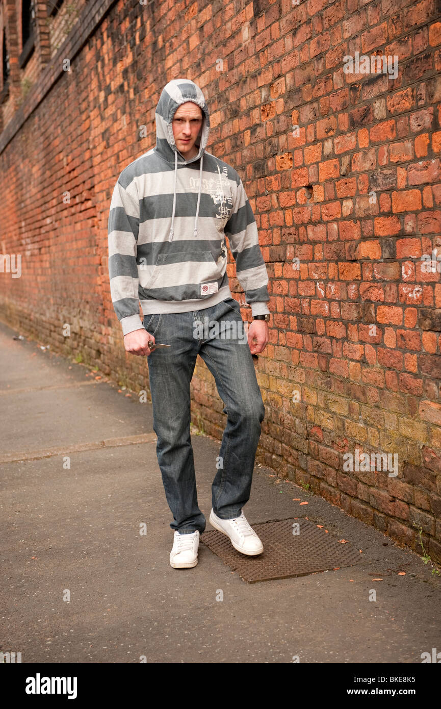 Young male thug criminal with knife and hooded top Posed by Models ...