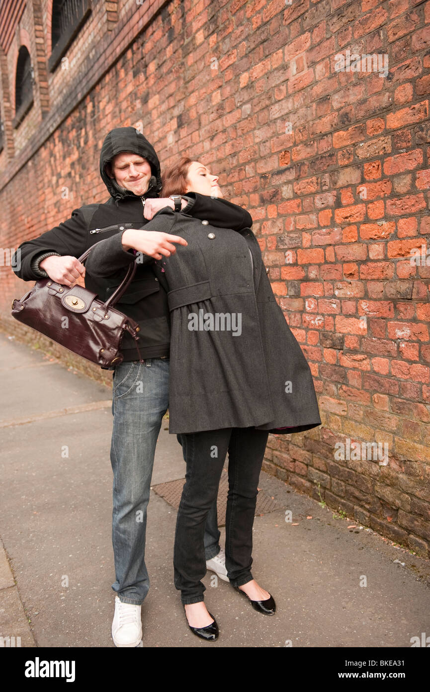 Lone woman walking along street with handbag thug / criminal attacking ...