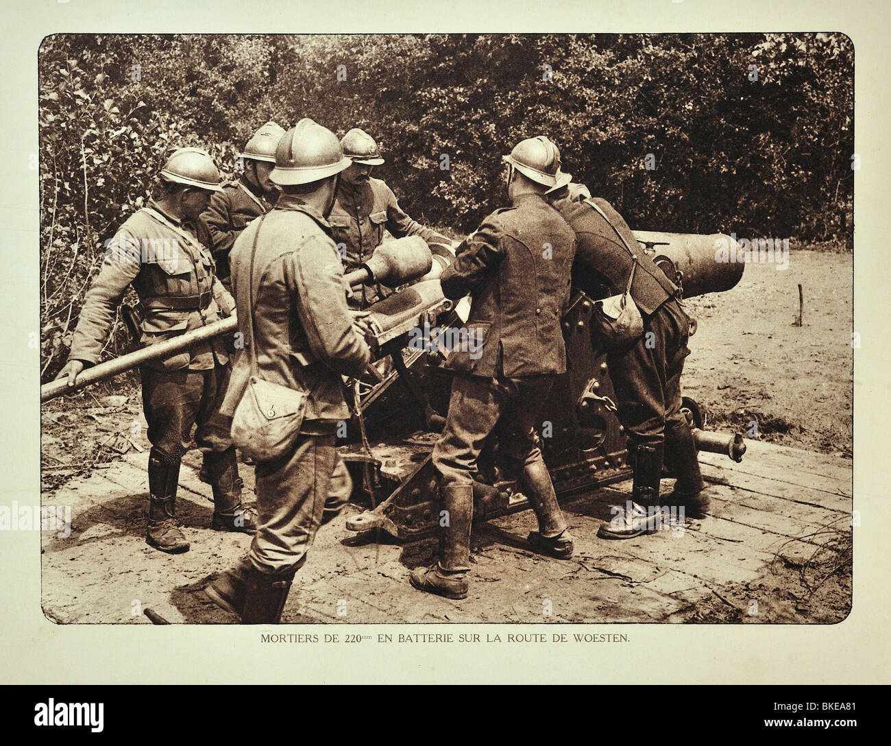 WWI artillery soldiers firing mortar / cannon at battlefield at Woesten ...