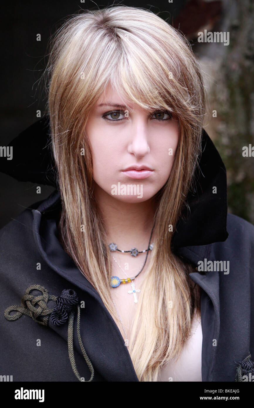teenage girl with pouting expression in black long hair Stock Photo - Alamy