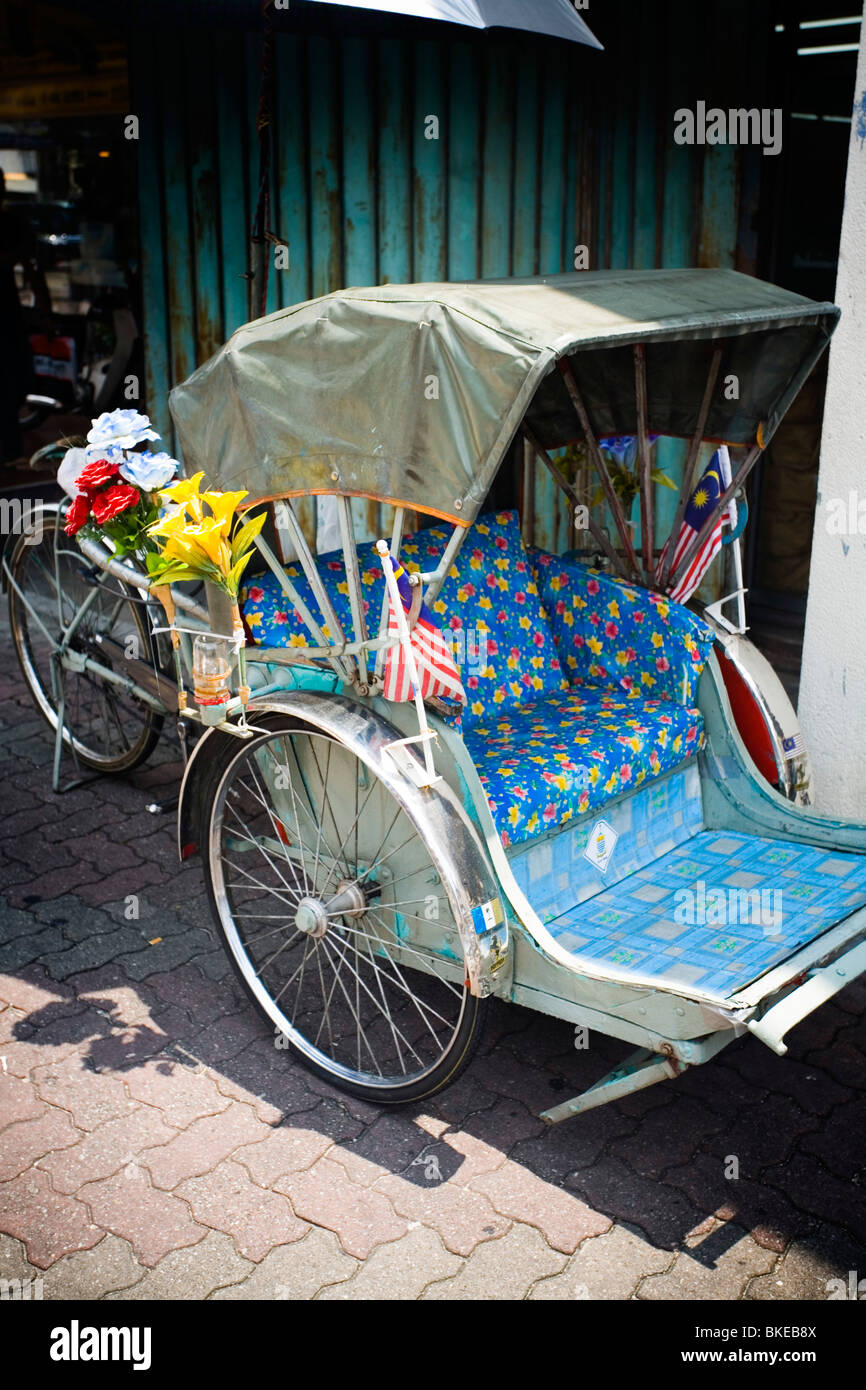 a single rickshaw parked in the shade Stock Photo - Alamy