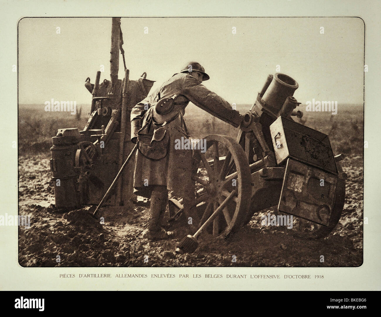 WW1 soldier looking at German captured mortars / cannons at battlefield ...