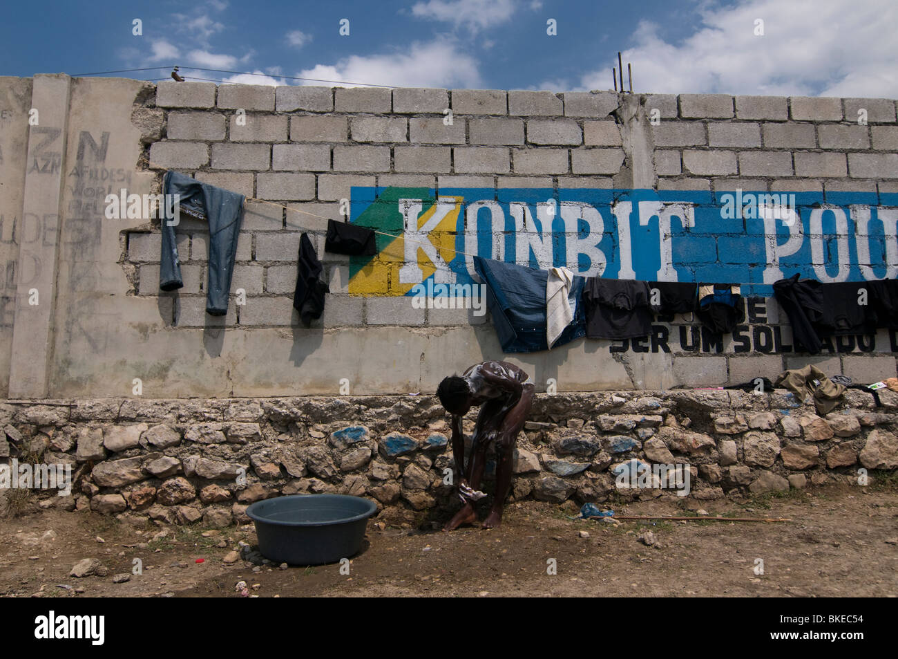 A person washing clothes at a makeshift camp for survivors of a 7.0 ...