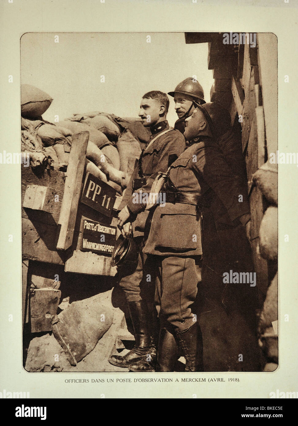 WWI officers in trench at observation post watching the battlefield at ...
