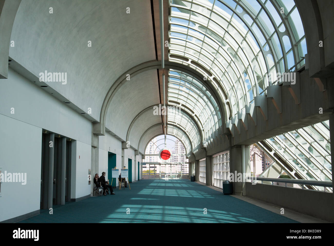 Sparsely populated hallway in San Diego Convention Center with curved ...