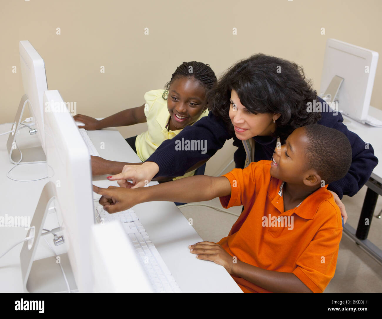 Teacher With Students In Computer Class Stock Photo - Alamy