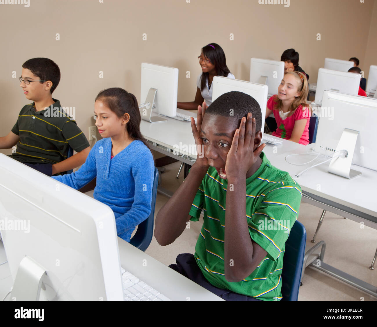 Student Surprised While Looking At His Computer In Computer Class Stock ...