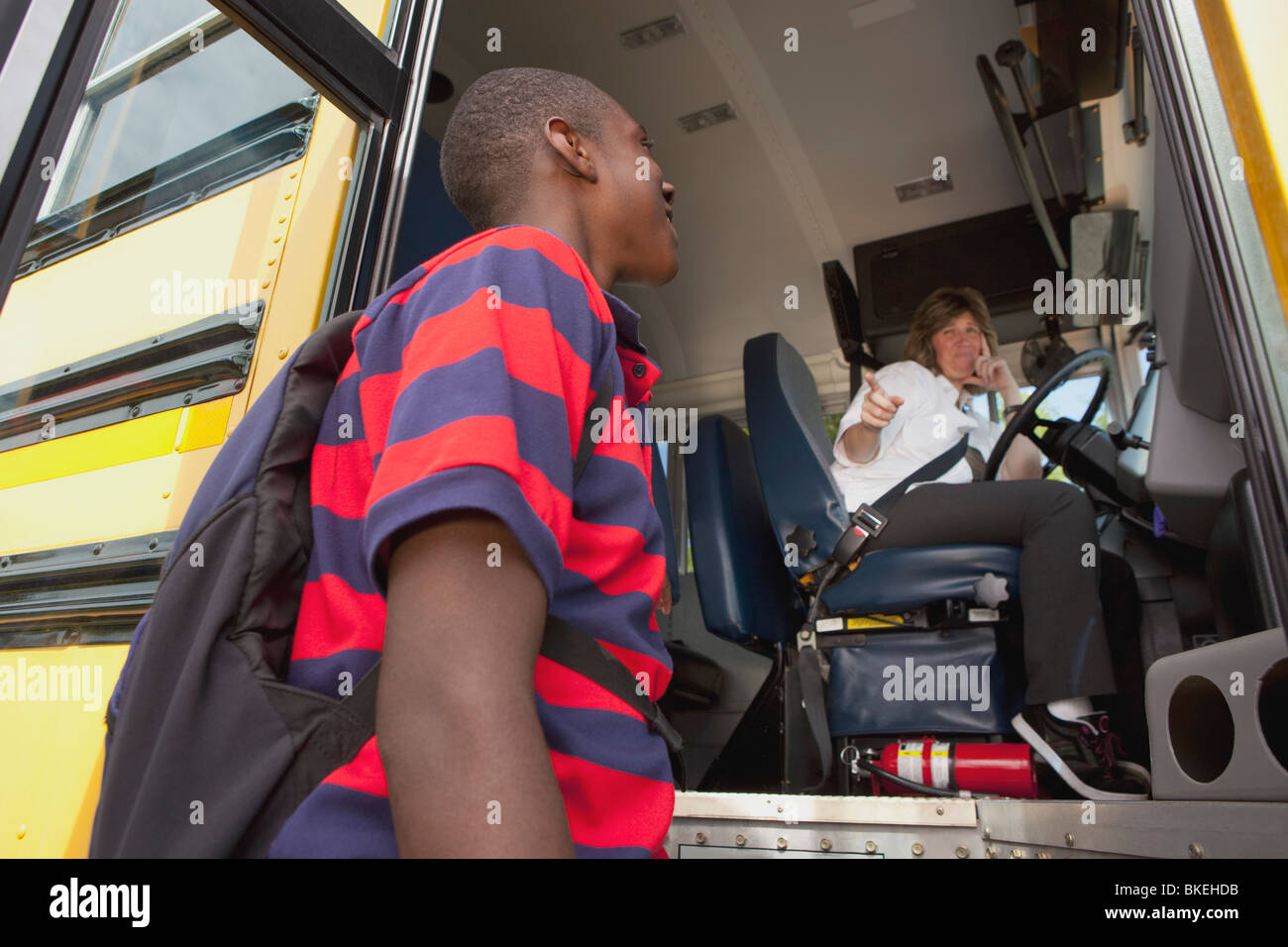 Student Greeting The School Bus Driver Stock Photo - Alamy