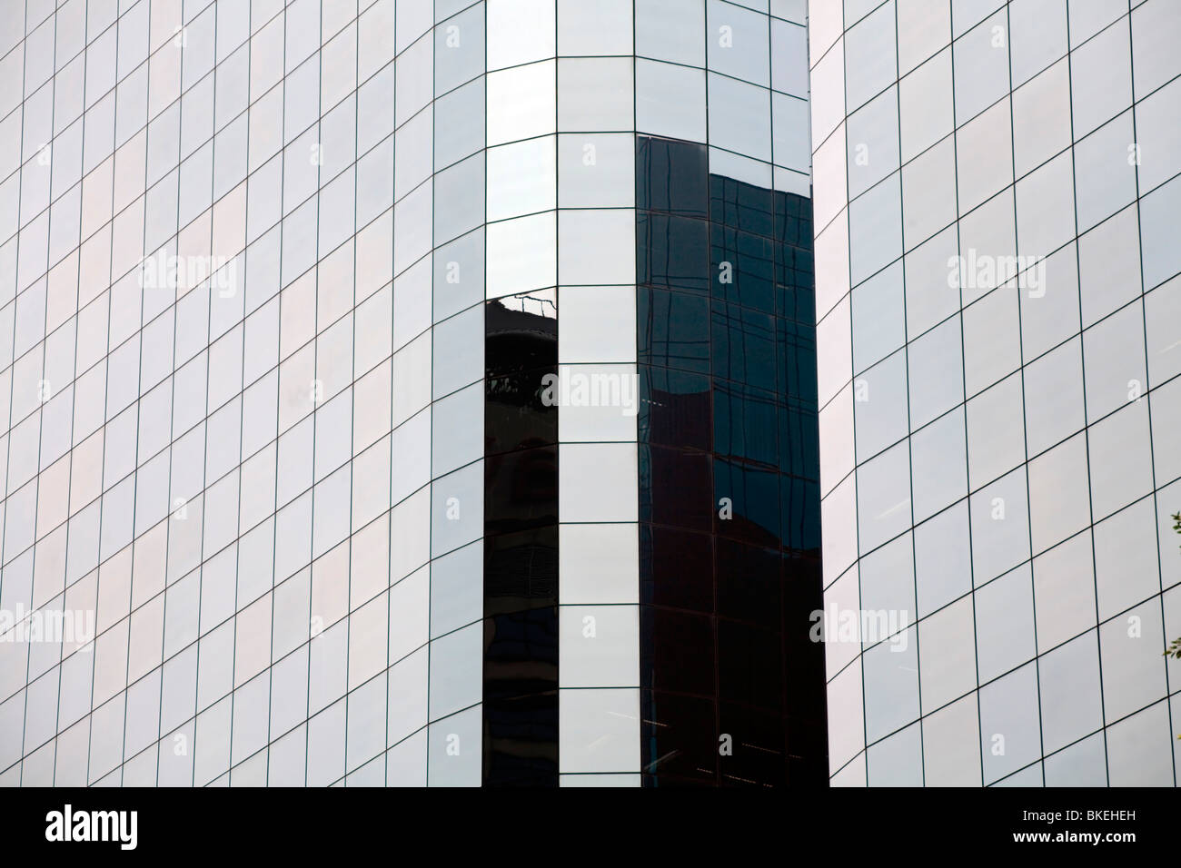 A tall business building with reflective windows Stock Photo - Alamy