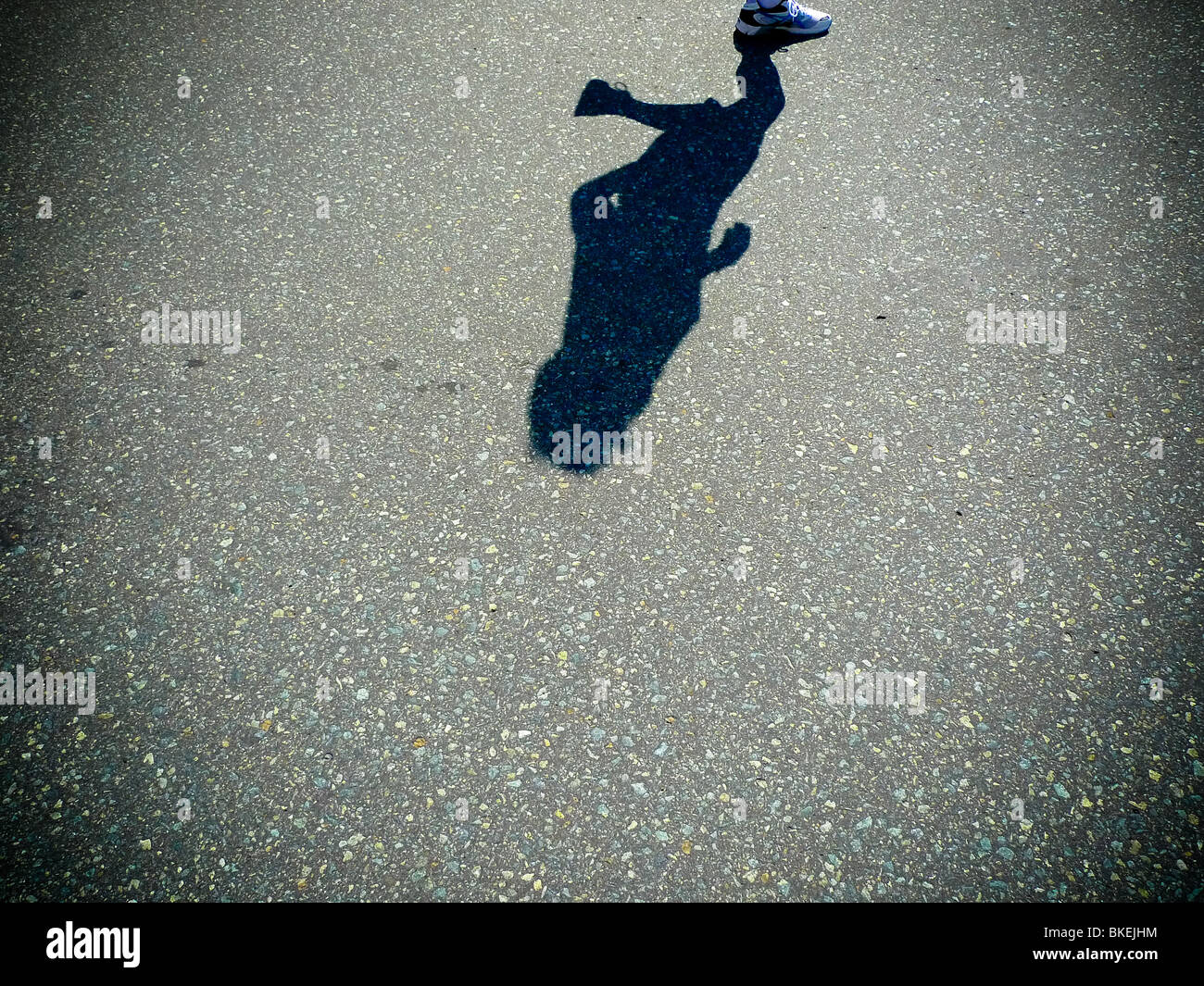 Shadows of runner's legs whilst competing in marathon road race Stock ...