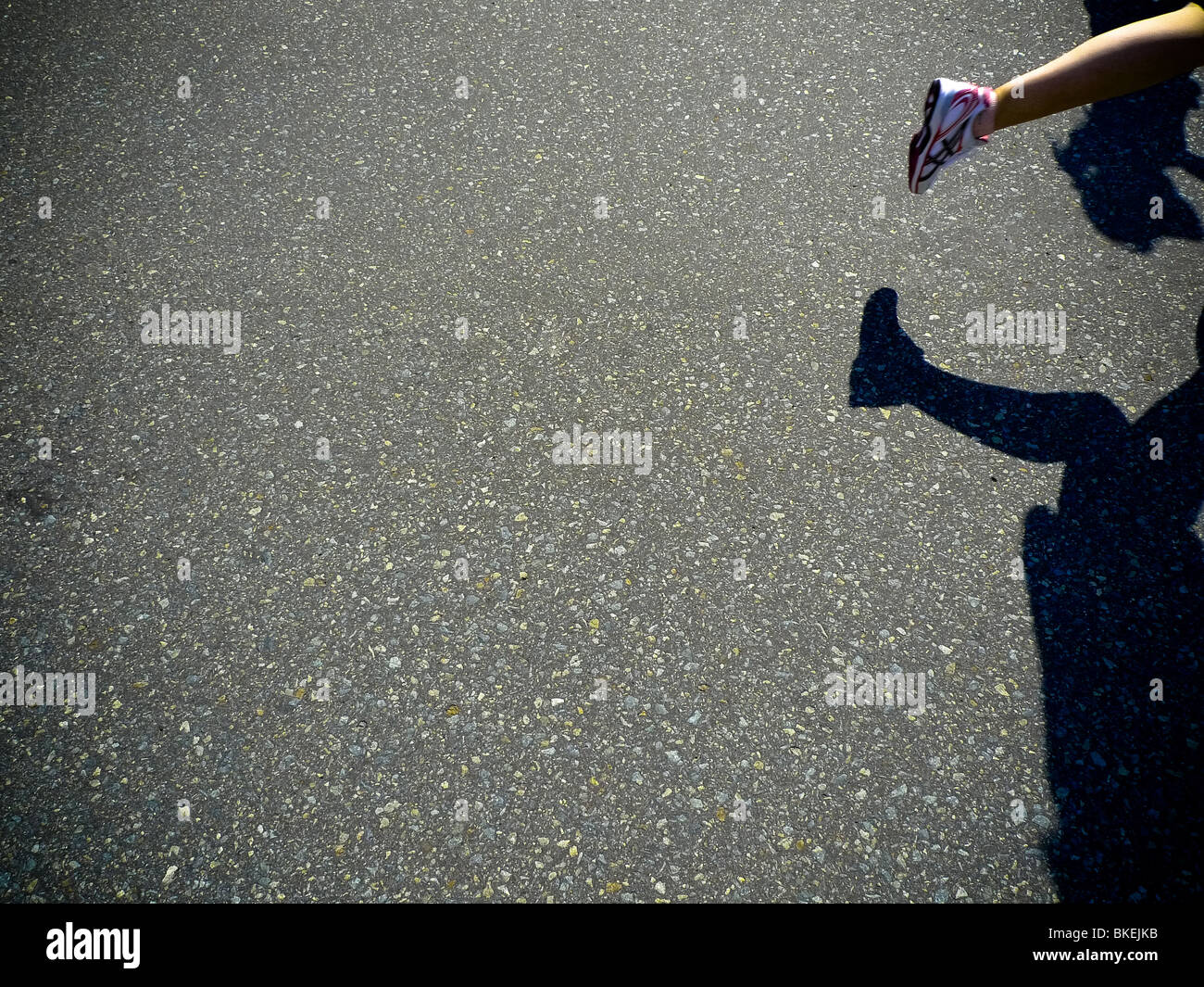 Shadows of runner's legs whilst competing in marathon road race Stock ...